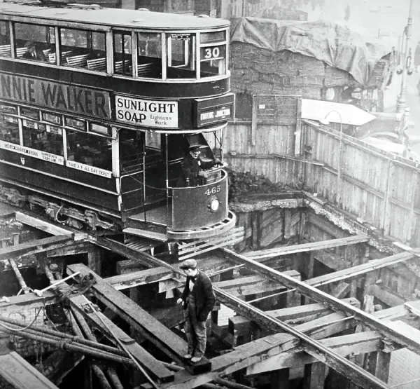 A London tram passing over cut and cover works during