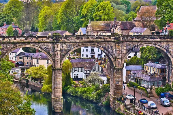 A picturesque view of a stone bridge arching over a river