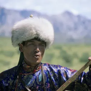 Tuvinian in traditional clothes on a horse wearing a