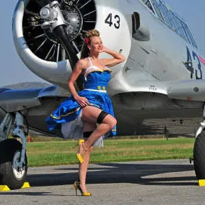 1940s Style Aviator Pin Up Girl Posing With A Vintage T 6 Texan